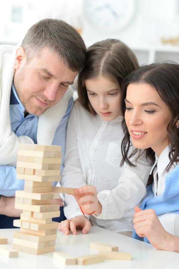 Family with Daughter Playing a Game Stock Photo - Image of parent, game ...