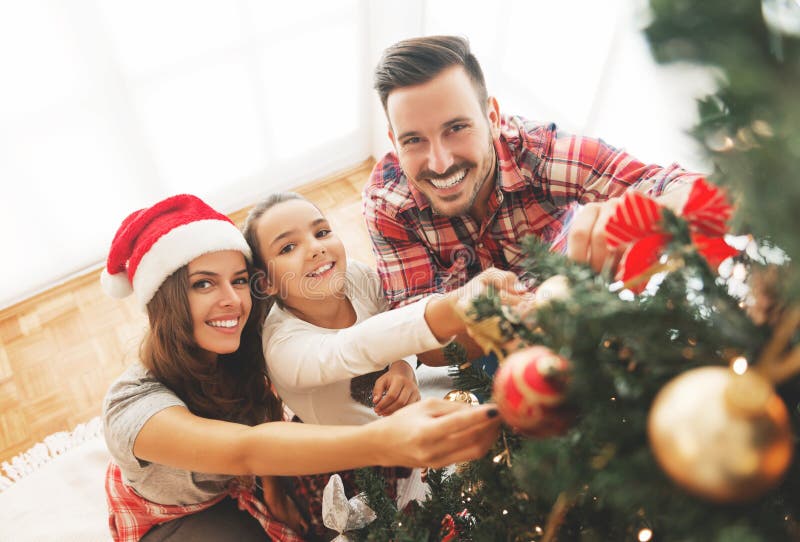 Family Decorating a Christmas Tree Stock Image - Image of happy, joyful ...