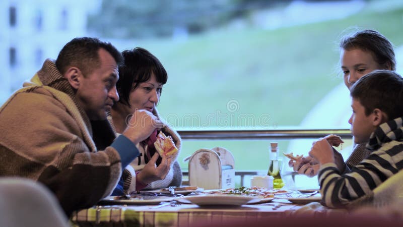 Family Dines at a Cafe, Eat Pizza Stock Photo - Image of dishware ...