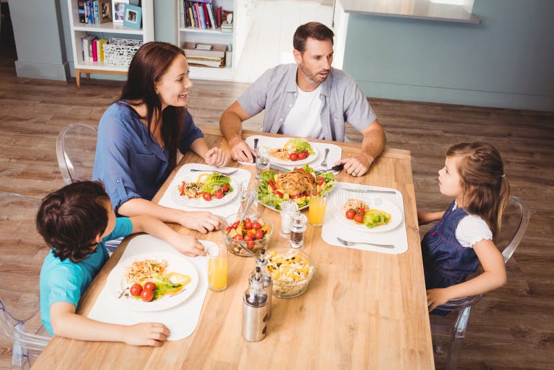 Family Discussing with Food on Dining Table Stock Image - Image of ...