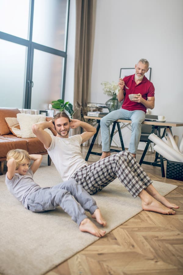 Family Doing Exercises at Home and Feeling Good Stock Photo - Image of ...