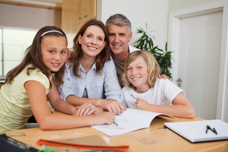 Family in Kitchen Doing Homework. Stock Photo - Image of guidance ...