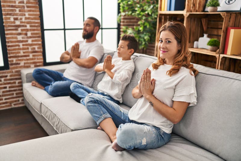 Family Doing Yoga Exercise Sitting on Sofa at Home Stock Image - Image ...