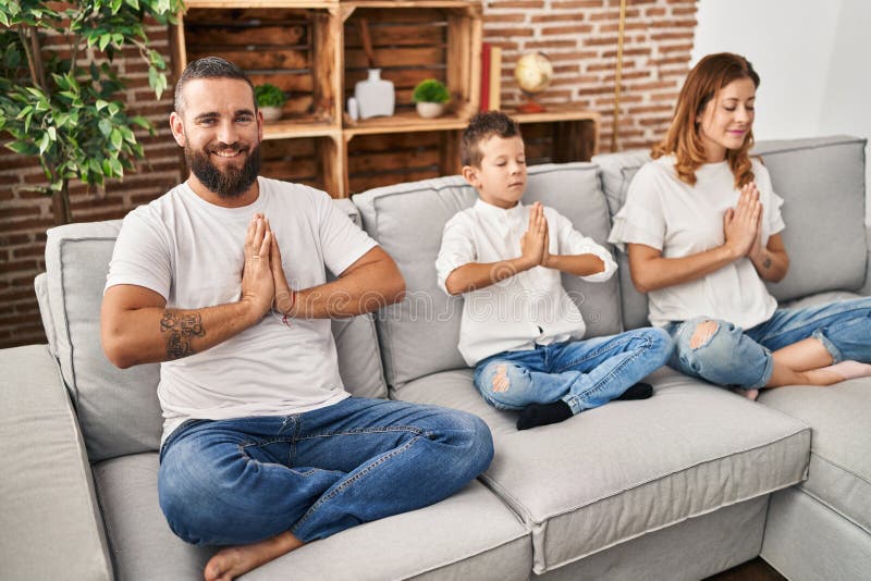 Family Doing Yoga Exercise Sitting on Sofa at Home Stock Photo - Image ...