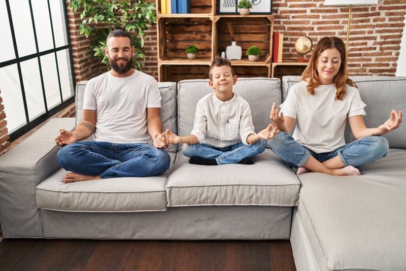 Family Doing Yoga Exercise Sitting on Sofa at Home Stock Photo - Image ...