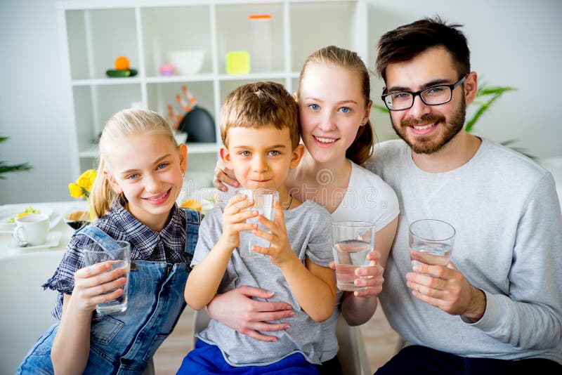 Family drinks water stock image. Image of male, kitchen - 93942755