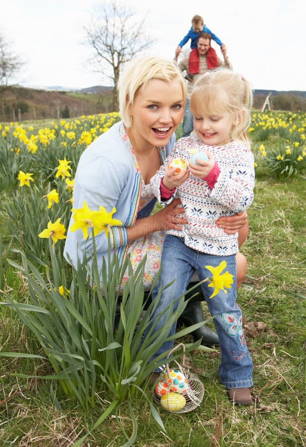 Family on Easter Egg Hunt in Daffodil Field Stock Photo - Image of ...