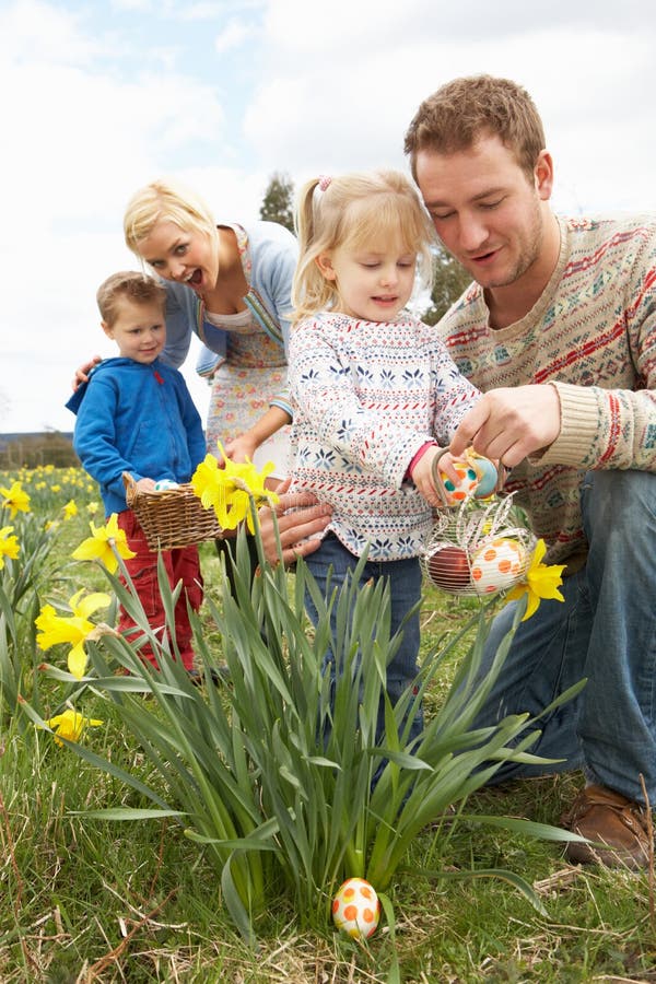 Family on Easter Egg Hunt in Daffodil Field Stock Photo - Image of ...