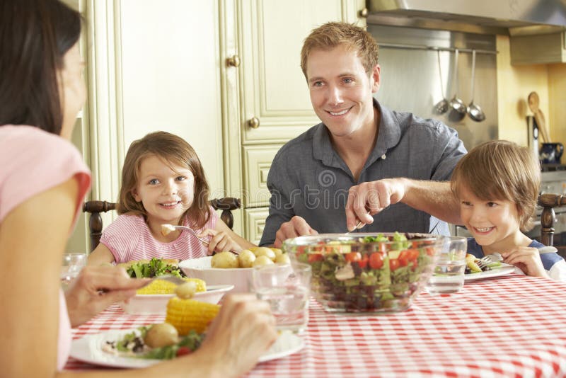 Family Eating Meal Together in Kitchen Stock Photo - Image of daughter ...