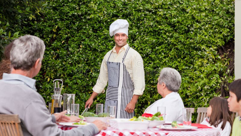 Family Eating Outside in the Garden Stock Photo - Image of grandfather ...