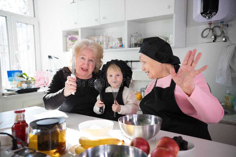 Family Eating Pancakes and Drinking Tea in the Kitchen. Posing for the ...