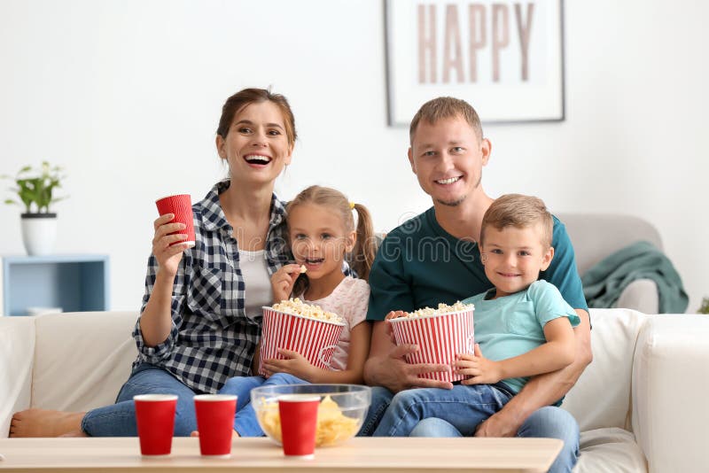 Family Eating Popcorn while Watching TV at Home Stock Photo - Image of ...