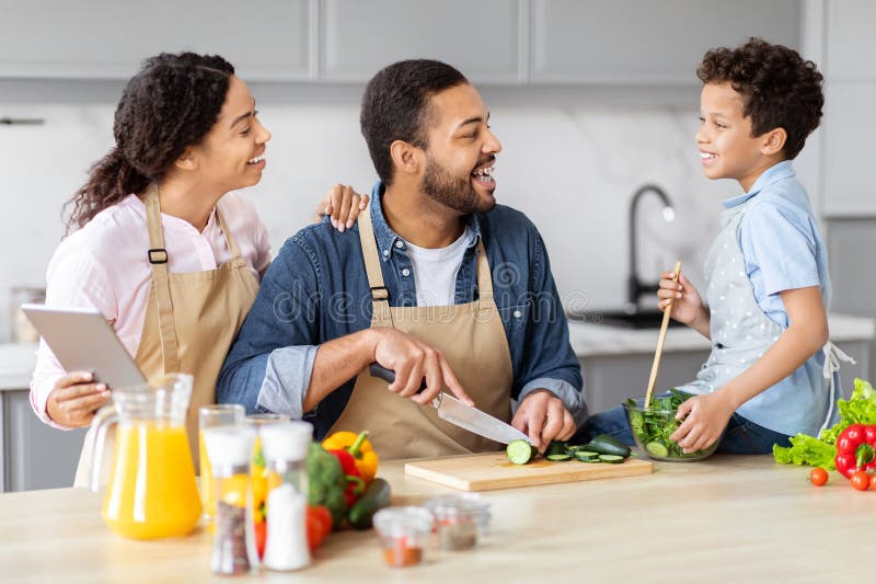 Family Engaged in Cooking and Digital Technology Stock Image - Image of ...