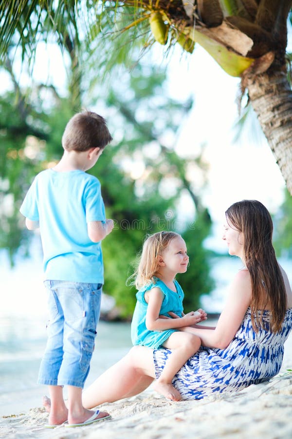 Family Enjoying Evening at Beach Stock Photo - Image of female, evening ...