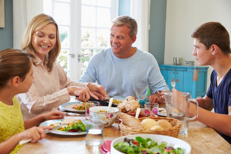 Family Enjoying Meal at Home Together Stock Photo - Image of caucasian ...