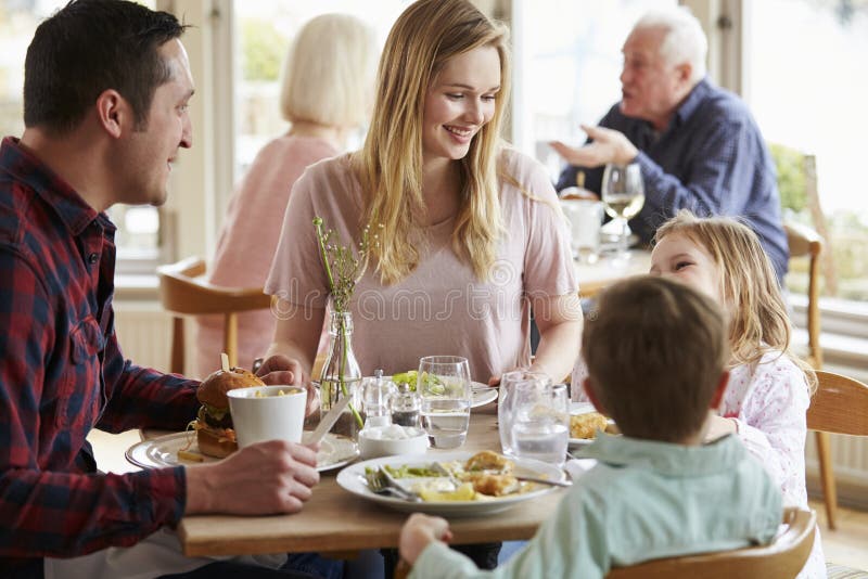 Family Enjoying Meal in Restaurant Together Stock Photo - Image of meal ...