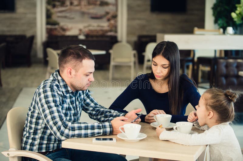 Family Enjoying Tea in Cafe Together Stock Image - Image of daughter ...