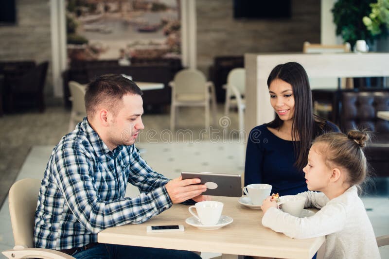 Family Enjoying Tea in Cafe Together Stock Image - Image of mother ...