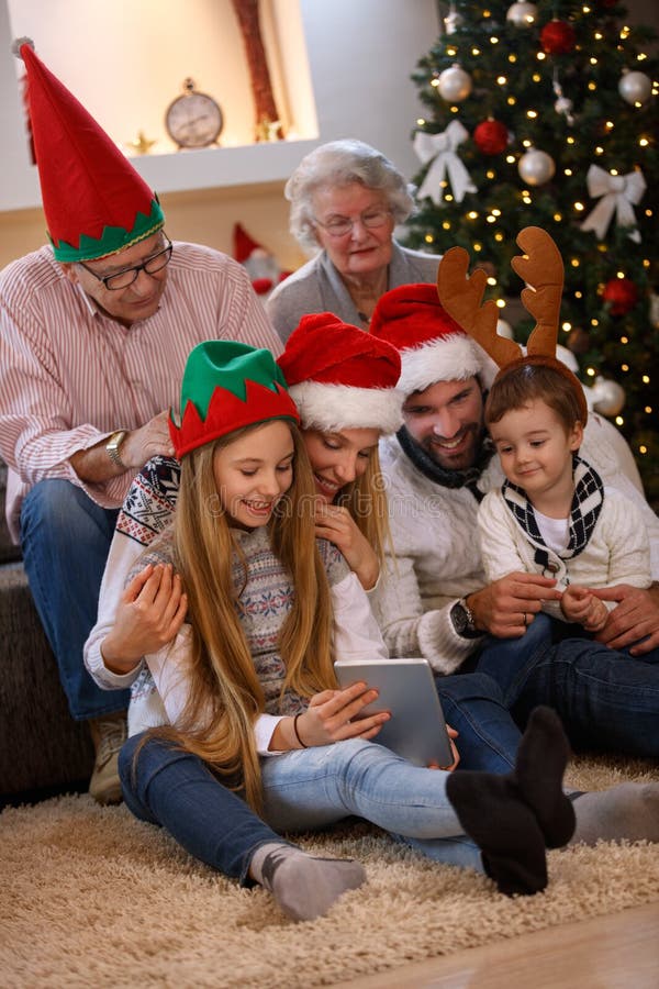 Family Enjoying Their Holiday Time Together Using Tablet Stock Photo ...