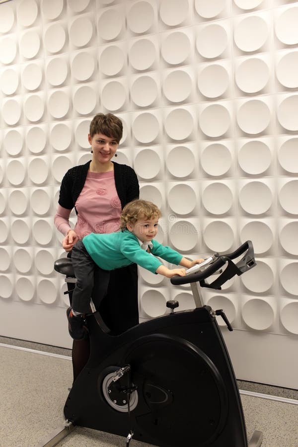 Family at exercise bicycle stock photo. Image of child - 36915706