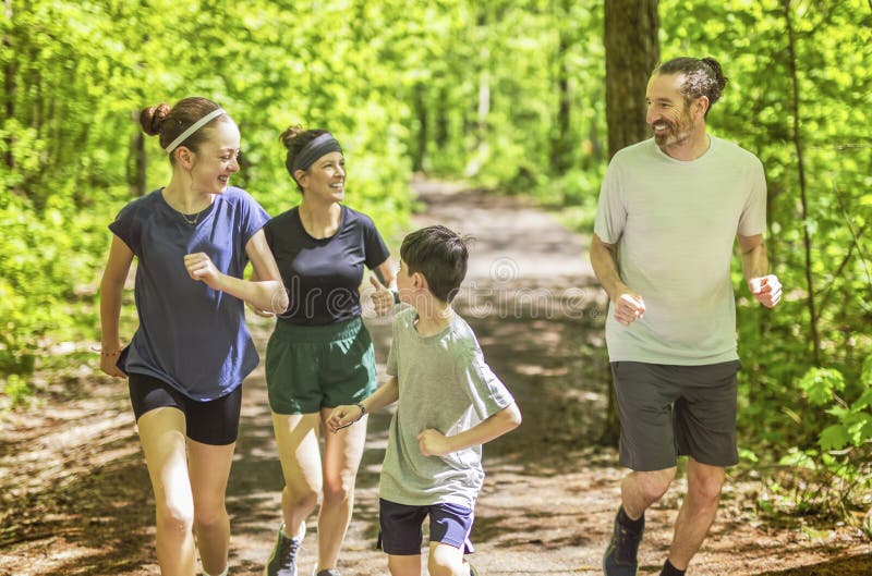 A Family Exercising and Jogging Together at an Outdoor Park Having ...