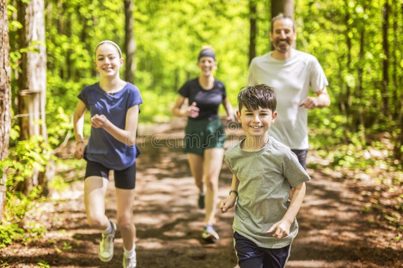A Family Exercising and Jogging Together at an Outdoor Park Having ...