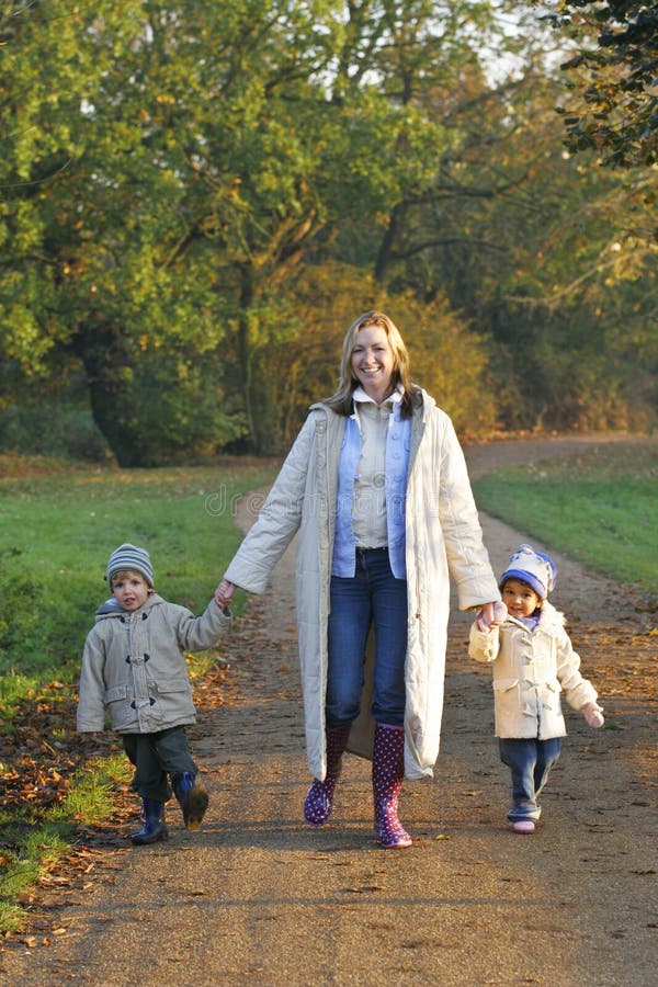 Mother and Her Children Running in the Park Stock Image - Image of ...