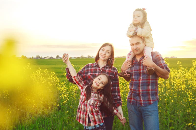 Family in the field. stock photo. Image of enjoying, smiling - 55555778