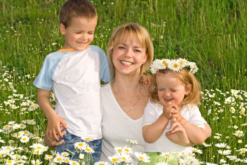 Family among flowers stock image. Image of blond, family - 5311563