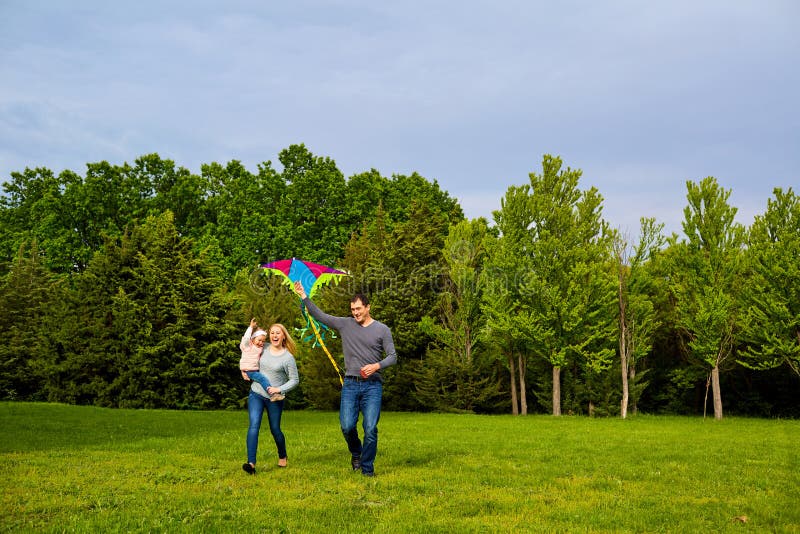 Family with Flying Kite in Park Stock Photo - Image of lifestyle ...