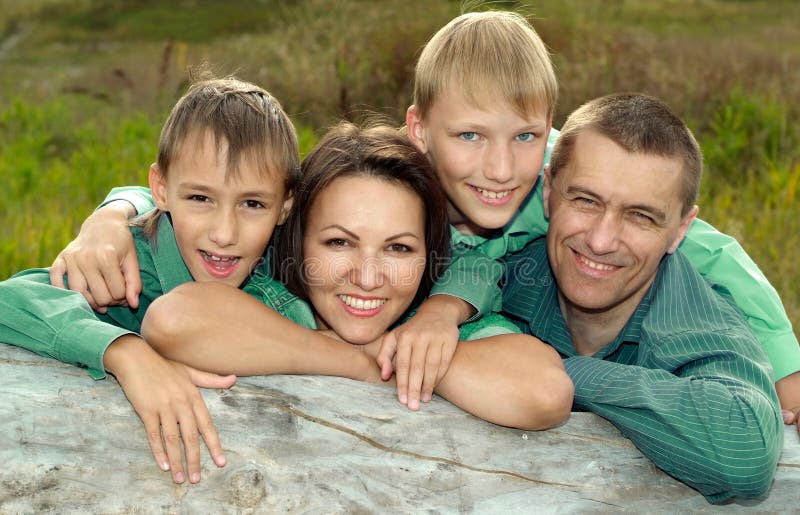 Family of a four stock image. Image of activity, outdoors - 27601317