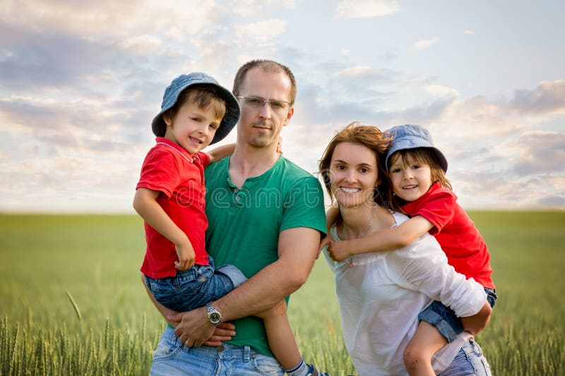 Family of Four, Mother, Father and Two Boys, Parent Looking at E Stock ...