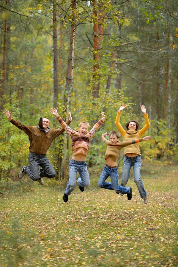 Family of Four Having Fun in Forest Stock Photo - Image of mushrooms ...