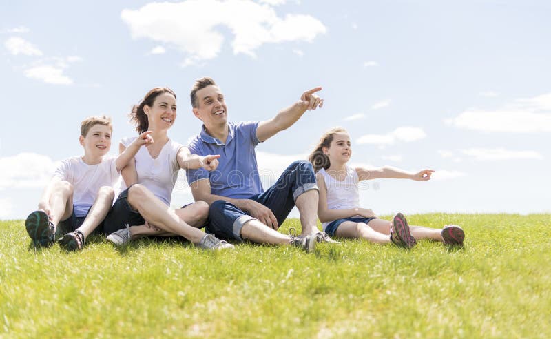 Family of Four Outdoors in a Field Having Fun Stock Image - Image of ...