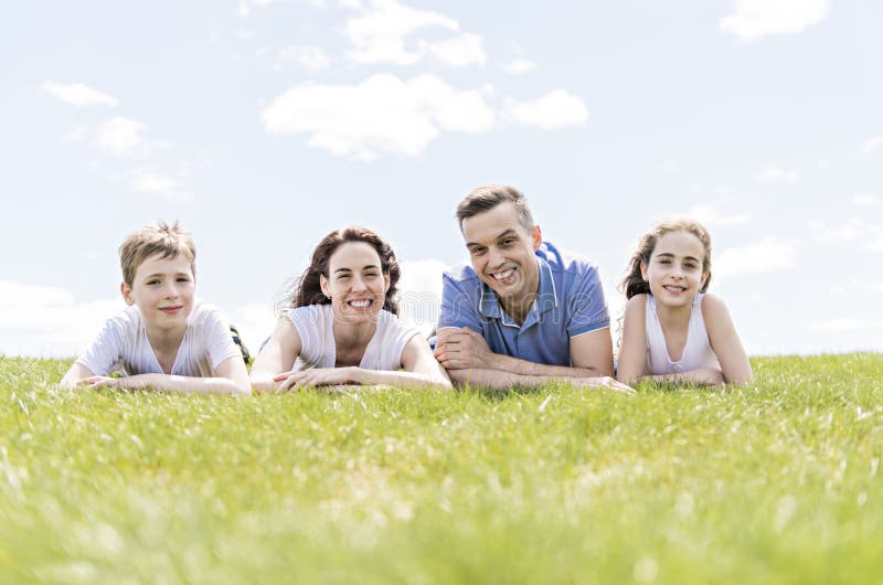 Family of Four Outdoors in a Field Having Fun Stock Photo - Image of ...