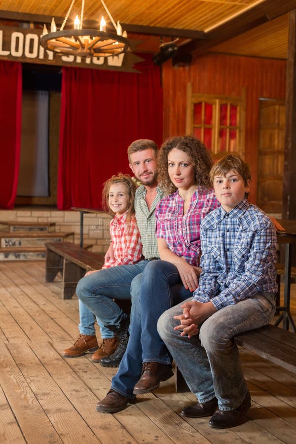 Family of Four Sitting on a Bench in Stock Image - Image of bench ...