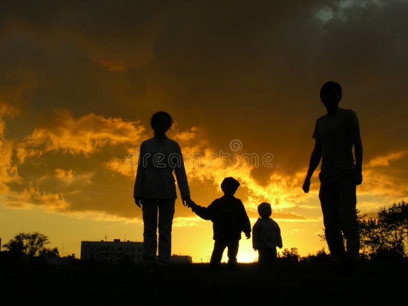 Family of four sunset 3 stock image. Image of life, hands - 1002747
