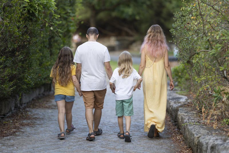 Family Walking Away in Park Holding Hands Stock Photo - Image of view ...