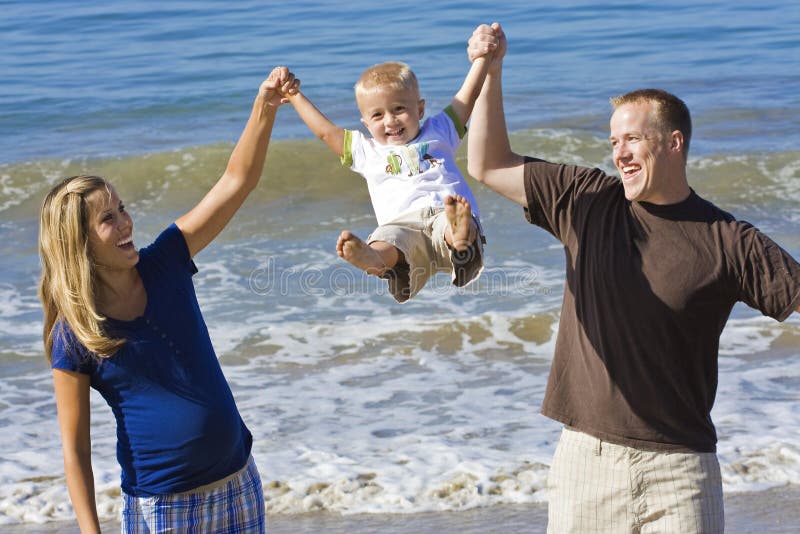 Family Fun on the Beach in the Sun Stock Photo - Image of hugging ...
