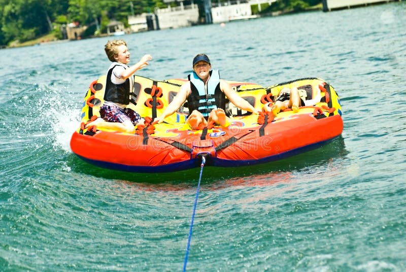 Family Fun on the Lake/Tubing Stock Photo - Image of enjoyment, pulling ...