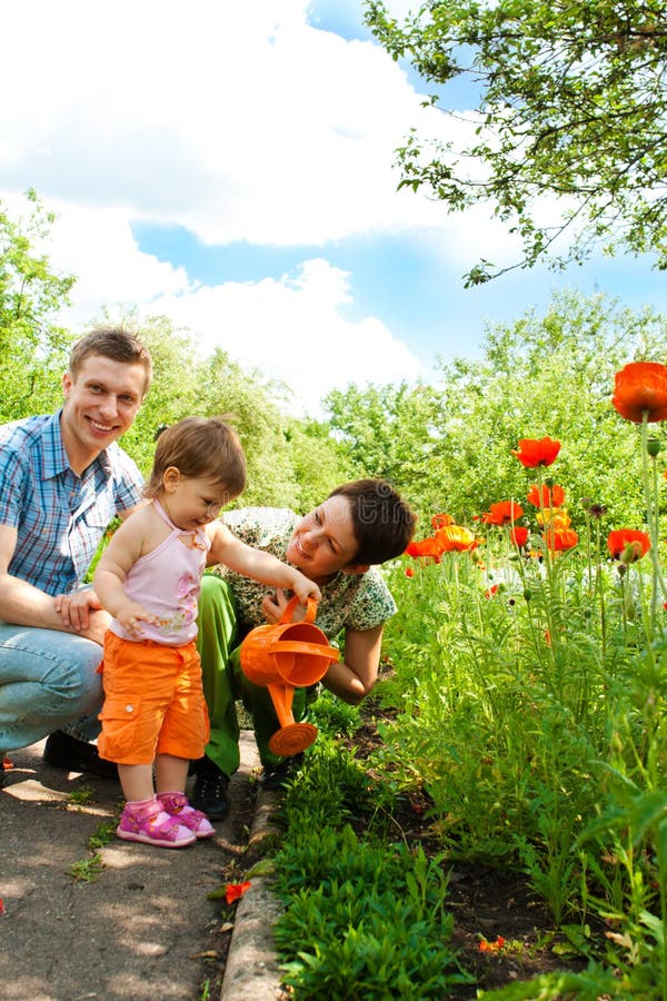 Family in the garden stock photo. Image of fresh, flower - 12684734
