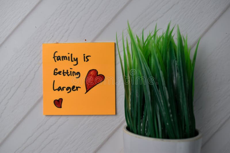 Family is Getting Larger Text on Sticky Notes with Office Desk Stock ...