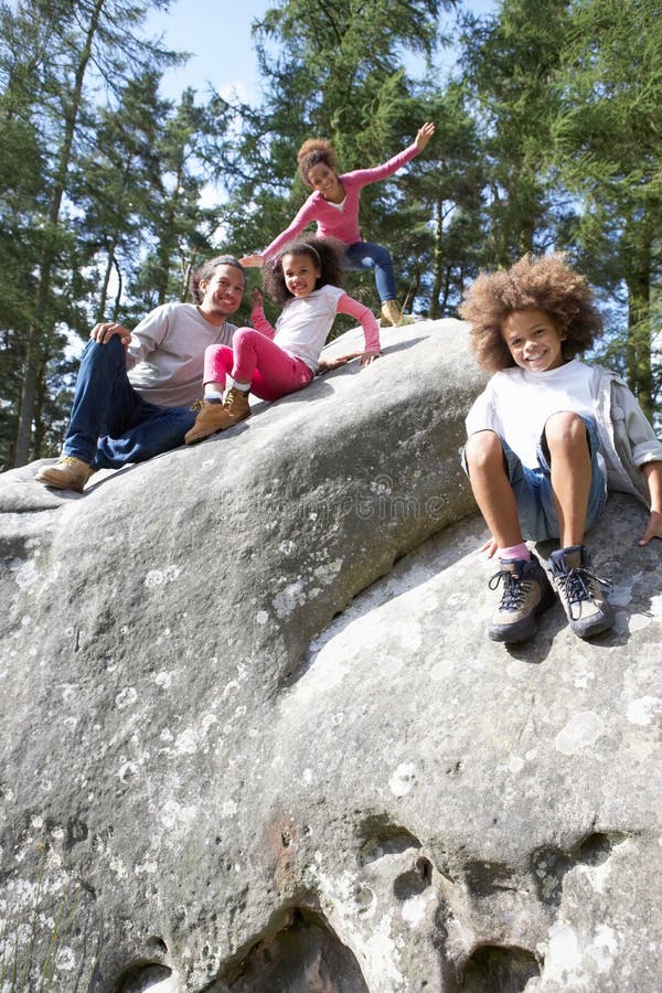 Family Group Sitting on Rock Together Stock Image - Image of people ...