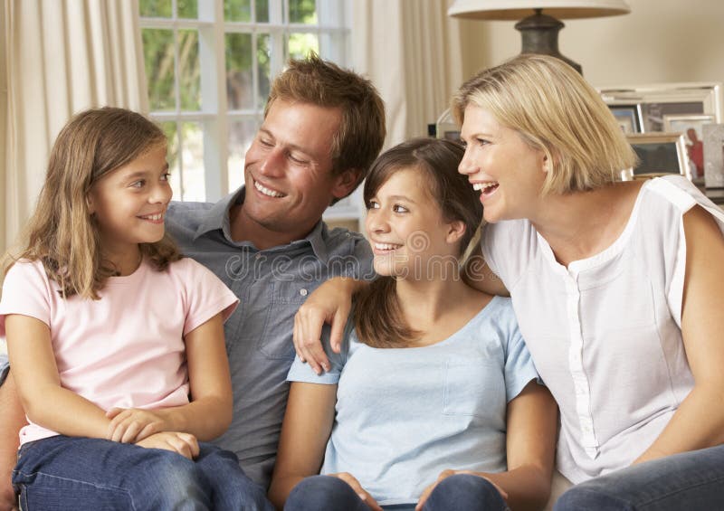 Family Group Sitting on Sofa Indoors Stock Photo - Image of teenage ...