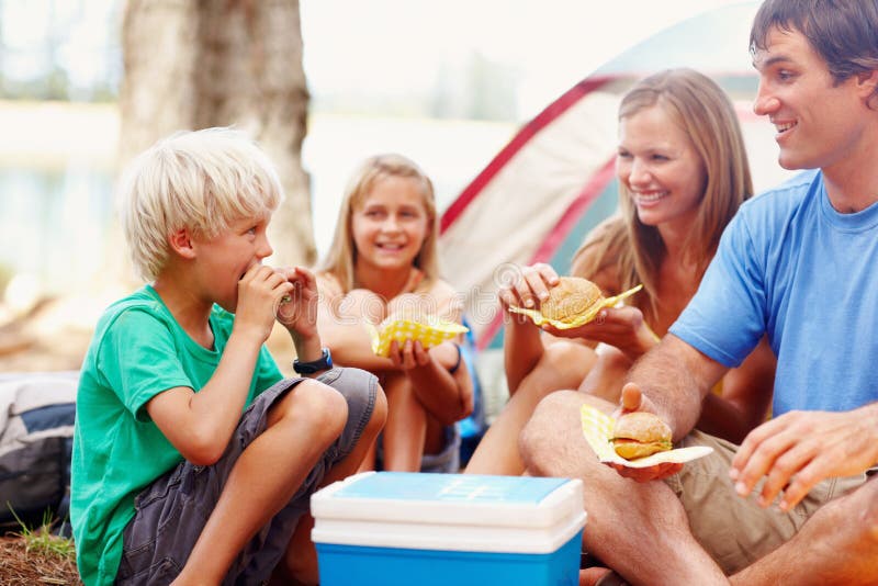 Family Having Breakfast while Camping. Family of Four Having Breakfast ...