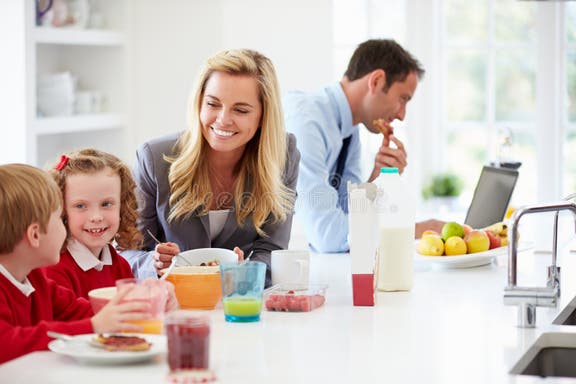 Family Having Breakfast in Kitchen before School and Work Stock Photo ...