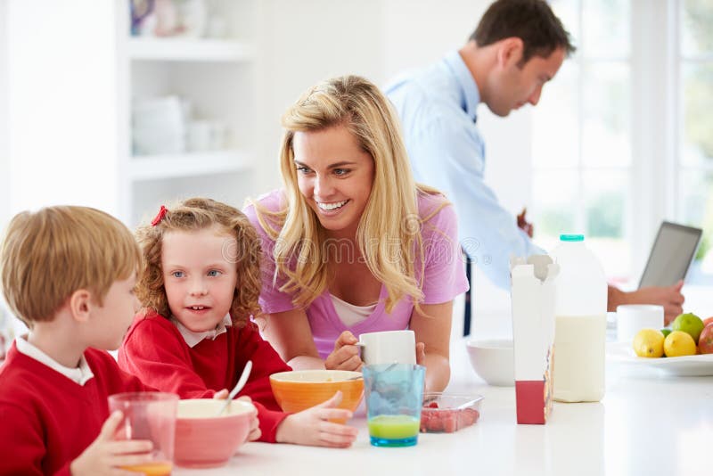 Family Having Breakfast in Kitchen before School and Work Stock Image ...