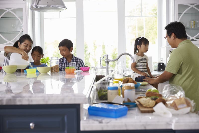 Family Having Breakfast and Making Lunches in Kitchen Stock Image ...