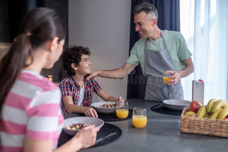 Family Having Breakfast Together and Looking Happy Stock Photo - Image ...