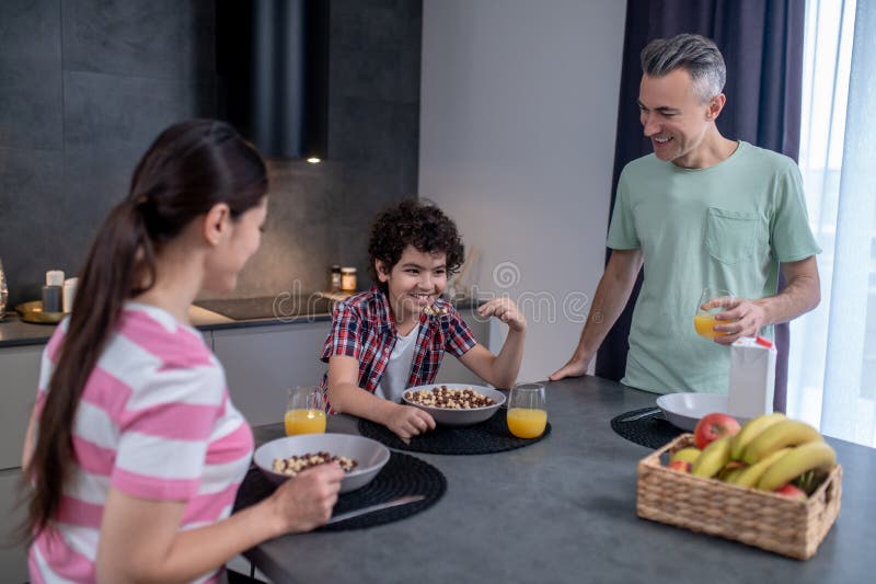 Family Having Breakfast Together and Looking Happy Stock Photo - Image ...